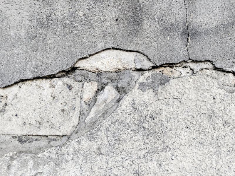 Peeling Cement Plaster on a Stone Wall. Deep Cracks and Traces of Stone ...