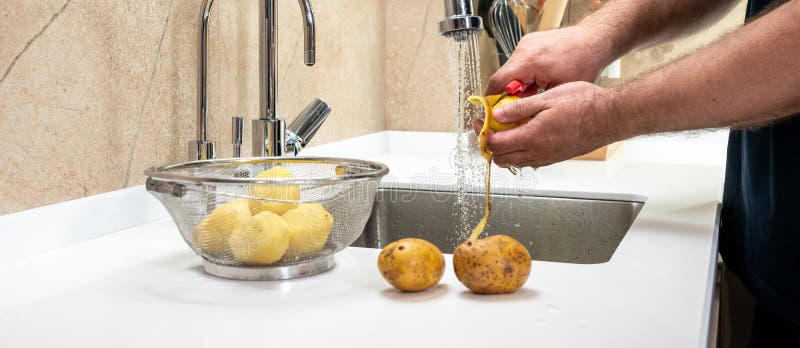 Peeling and Cooking Potatoes in the Kitchen in the Sink Stock Photo ...