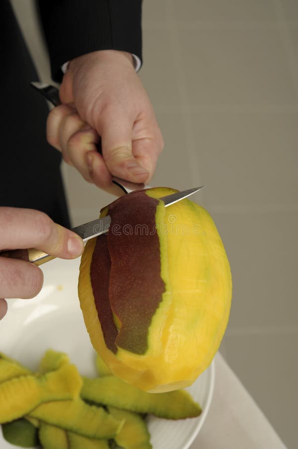 Peeling a mango stock photo. Image of indoors, peel, ingredient - 23708918
