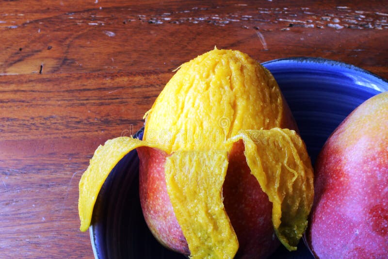 Peeling a mango stock photo. Image of indoors, peel, ingredient - 23708918