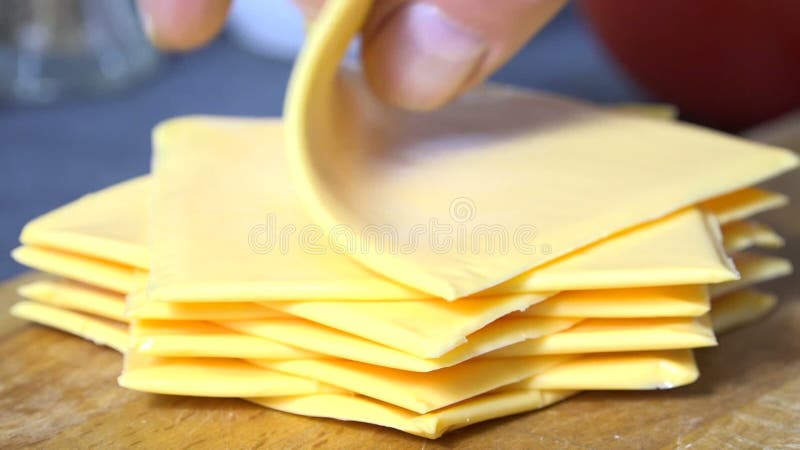 Peeling a Slice of Cheese Off a Stack of Processed Cheese Slices Stock ...