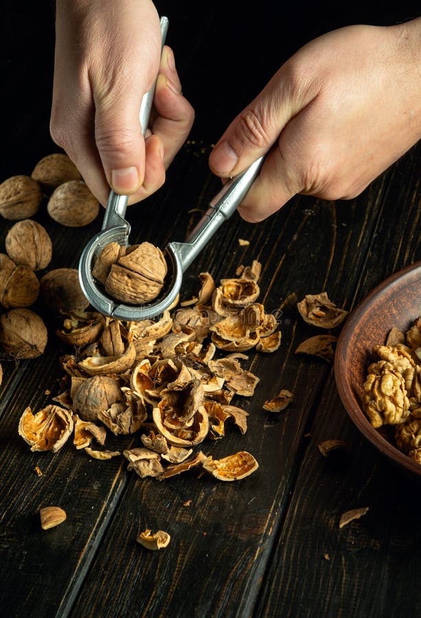 Peeling Walnuts from a Hard Shell by the Hands of Chef Using a ...