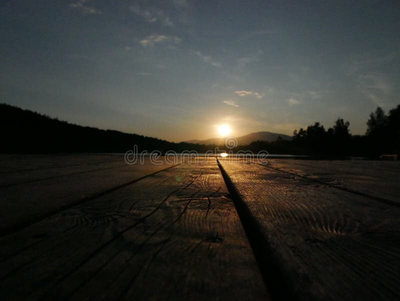 A Peer on a Lake with a Sunset Stock Image - Image of hour, building ...