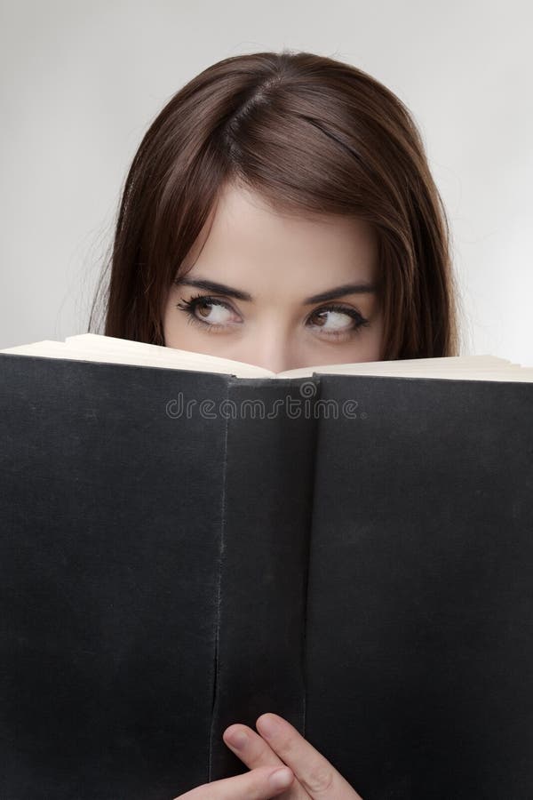 Peering over book stock photo. Image of novel, pretty - 33995662