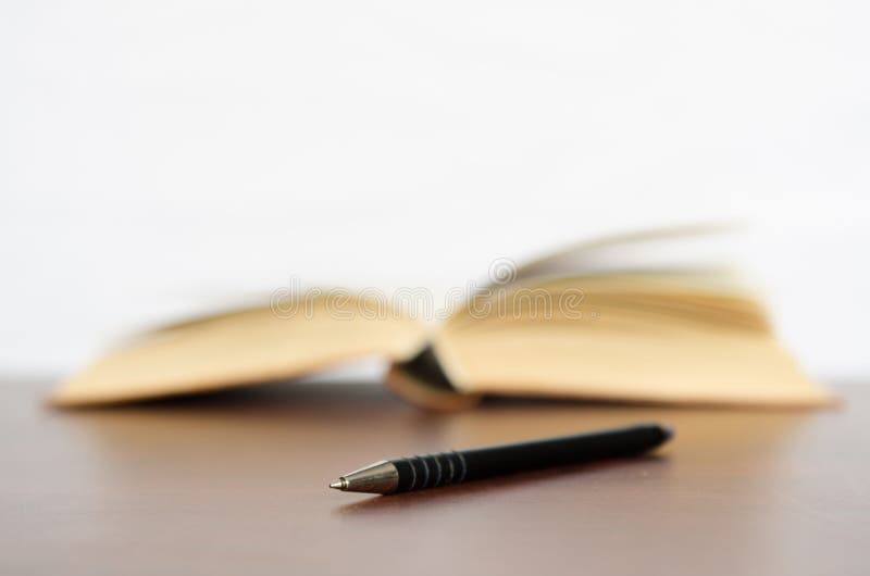 Pen on Background of a Stack of Colorful Books Stock Photo - Image of ...