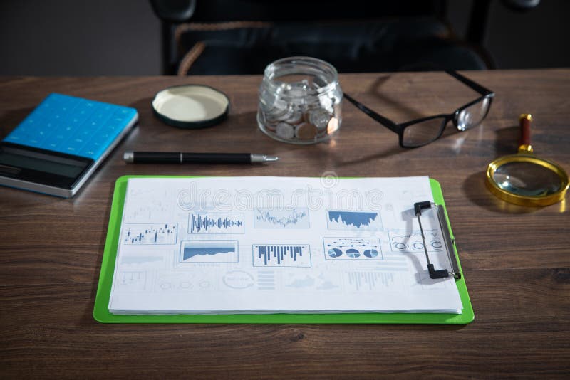 Pen, Calculator, Magnifying Glass with a Financial Graphs Stock Photo ... Pen, Calculator, Magnifying Glass with a Financial Graphs Stock Photo ...