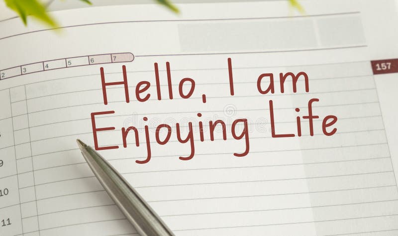 A Pen is on a Calendar with the Words Hello, I am Enjoying Life Written ...