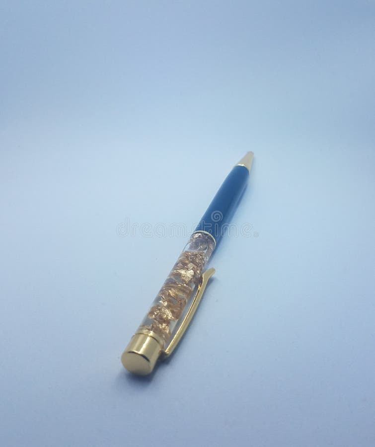 Pen with Gold Flakes or Nuggets on White Background Stock Photo - Image ...