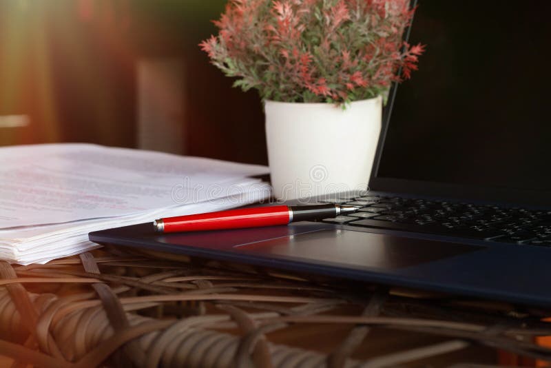 Pen on Laptop on Table with Blurred Paperwork Stock Photo - Image of ...