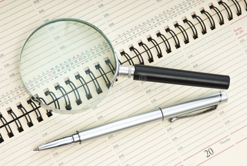 Pen and magnifying glass stock photo. Image of making - 16557078