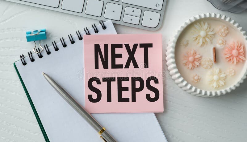 A Pen and a Notebook with a Pink Sticky Note that Says Next Steps Stock ...