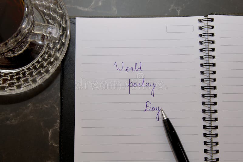 A Pen is on a Notebook with the Words World Poetry Day Written on it ...