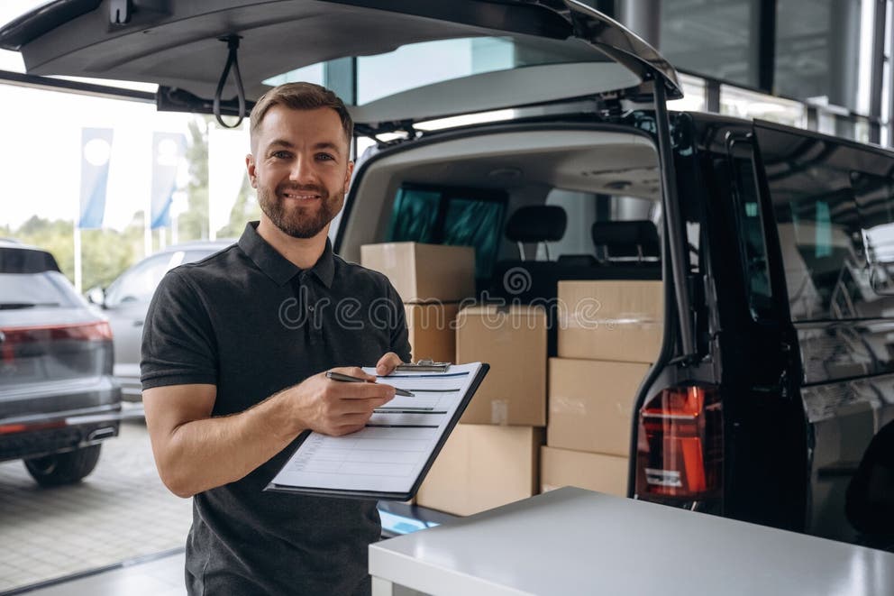 Pen and the Notepad in Hands. Delivery Man or Loader is Near the Car ...
