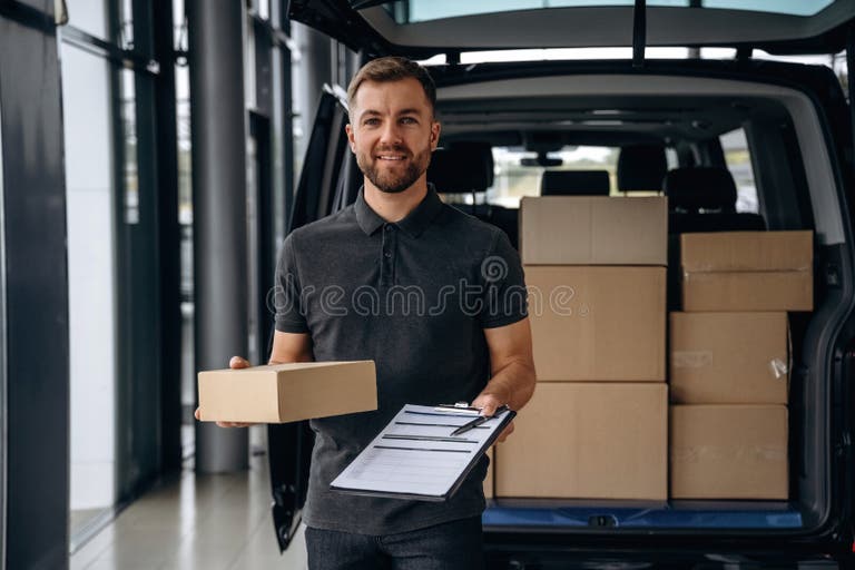 Pen and the Notepad in Hands. Delivery Man or Loader is Near the Car ...
