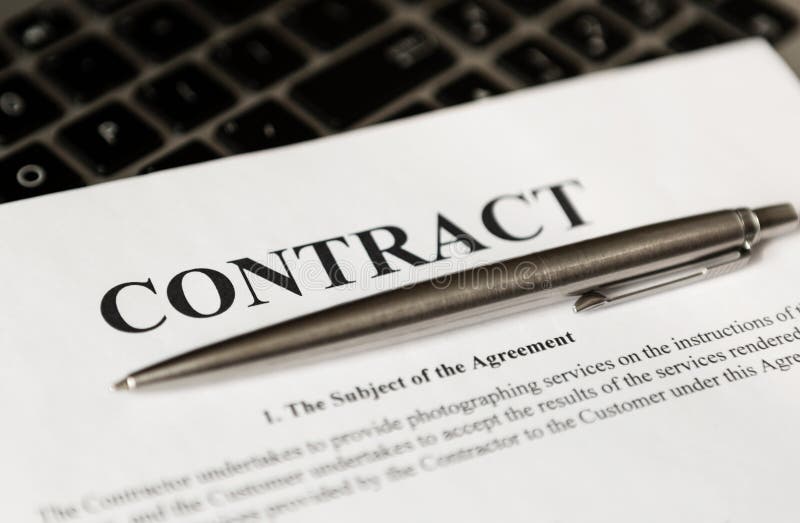Pen for Signing the Contract. the Pen and Contract are on the Laptop ...