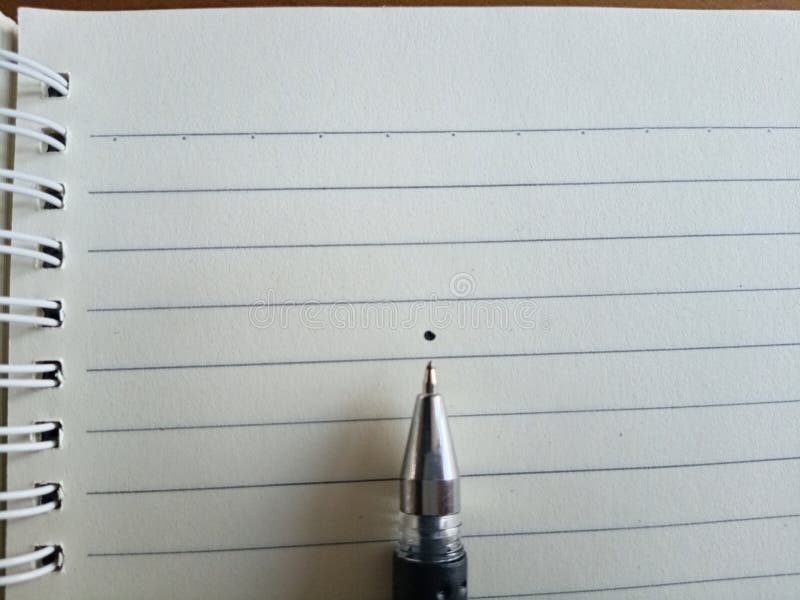 Pen and Single Dot Above Ruled Spiral Binding Notebook Page Stock Image ...