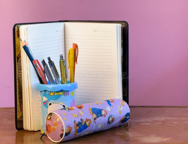 Pen Stand with Diary with Pink Background Stock Image - Image of ...