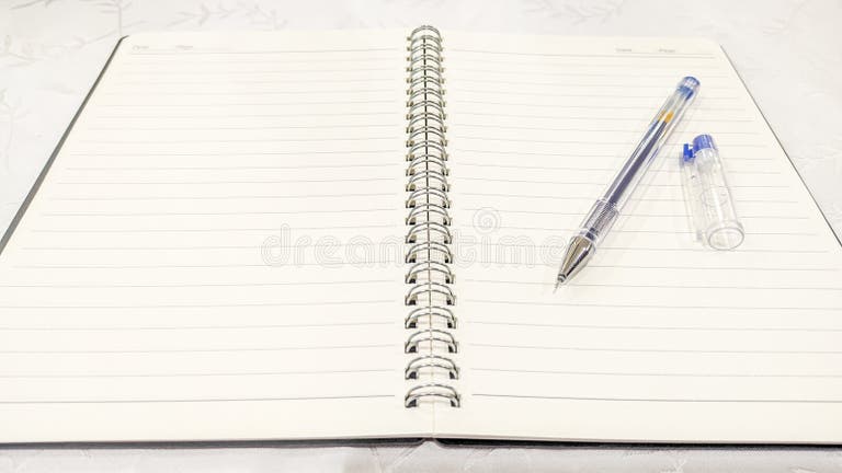 The Pen on Top of the Notebook. a Notebook that is Open on Both Sides ...