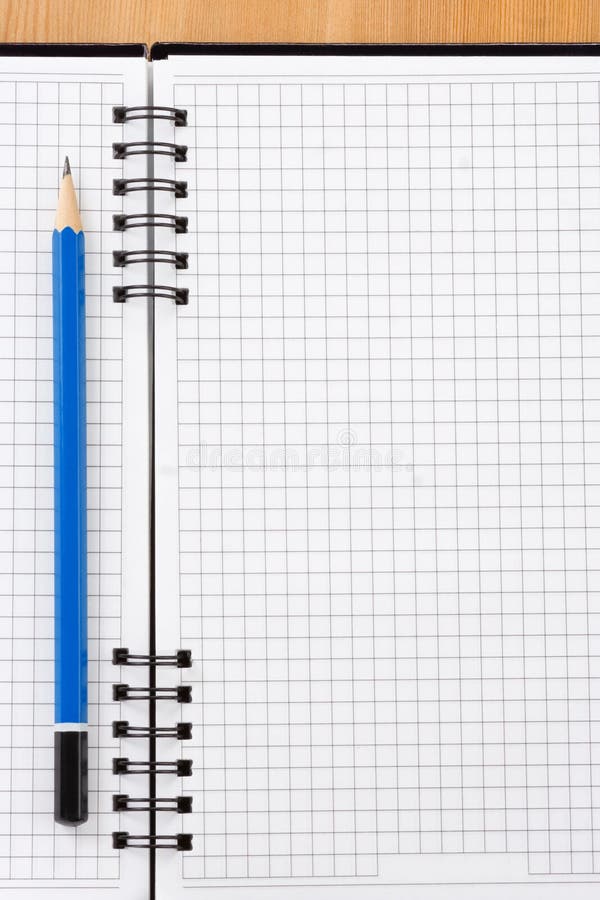 Pencil on checked notebook stock photo. Image of space - 24054598