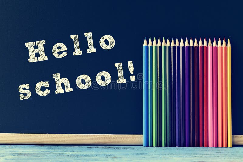Pencil Crayons and Text Hello School Written on a Chalkboard Stock ...