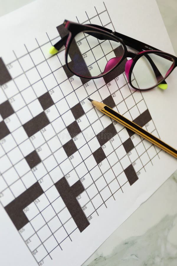 Pencil and Glasses on the Paper with Solved Crossword Puzzle Stock ...