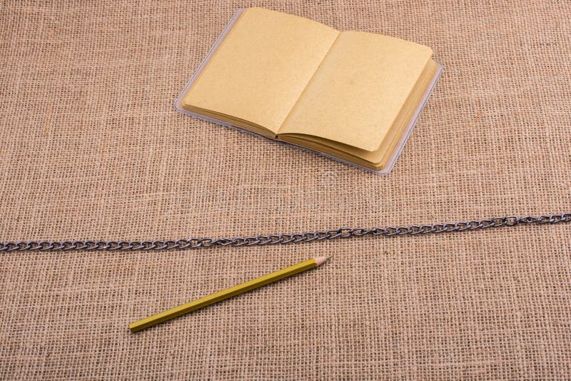 Pencil and Notebook with a Chain in the Middle Stock Photo - Image of ...