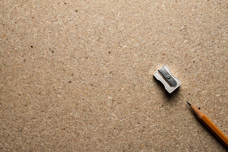 Pencil and Sharpener on a Chipboard Table. Top View Stock Photo - Image ...