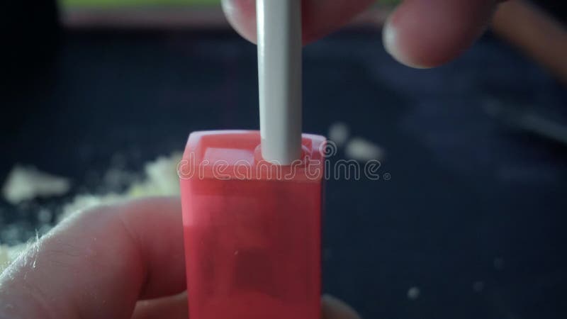 Pencil Sharpener. a Man Sharpens a White Pencil, a Stationery Stock ...