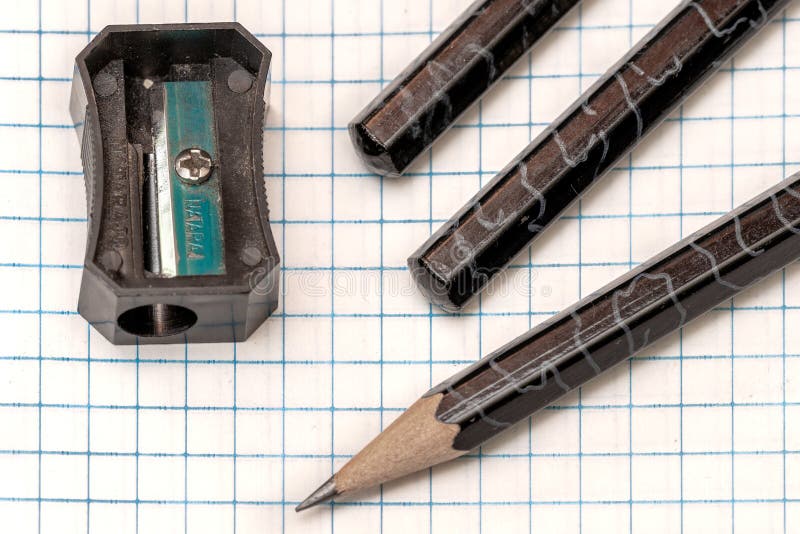 Pencil Sharpener and Pencils on Squared Paper. Top View with Space for ...