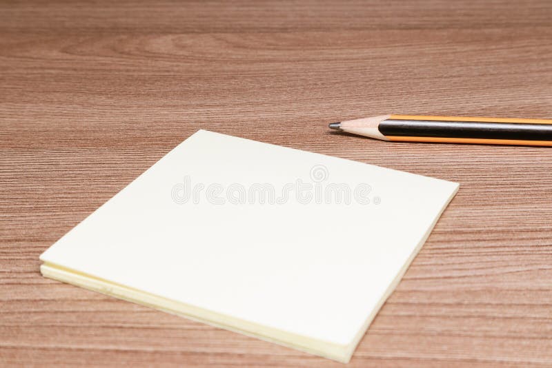 A Pencil and Sticky Notes Stand on a Wooden Table Stock Photo - Image ...
