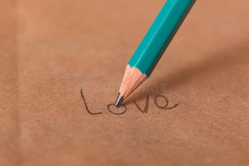 The Pencil Writes the Word Love on a Paper Stock Image - Image of sign ...