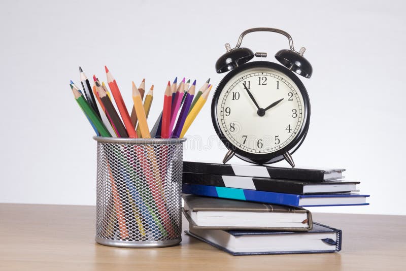 Pencils in Container with Alarm Clock on Books Stock Photo - Image of ...