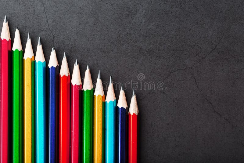 Pencils of Different Colors in a Row on a Black Textured Background ...