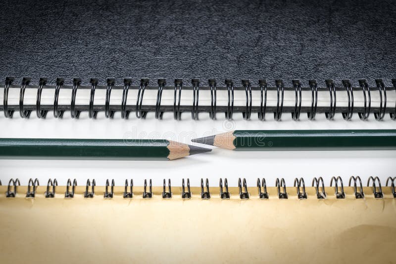 Pencils between note books stock image. Image of book - 91412353