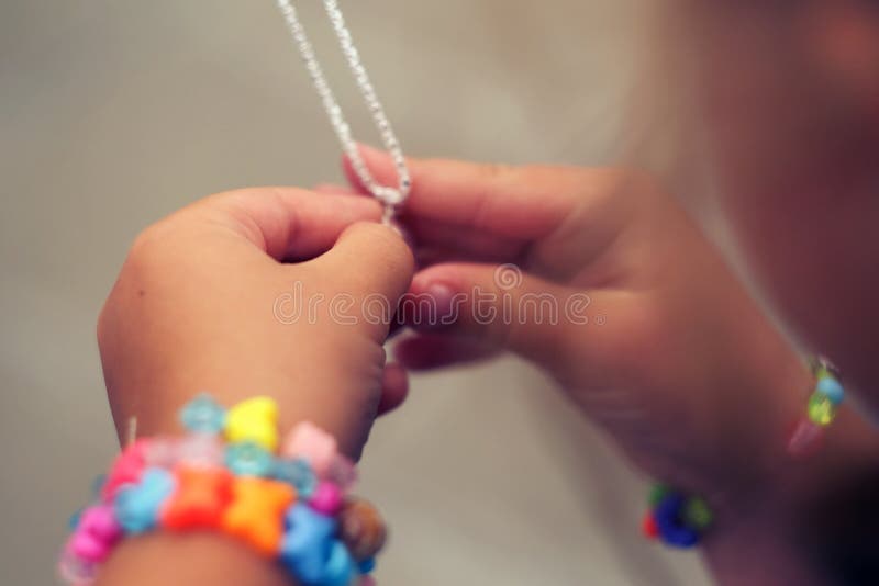 Children& X27;s Hands Holding a Beautiful Chain with a Pendant so Close ...