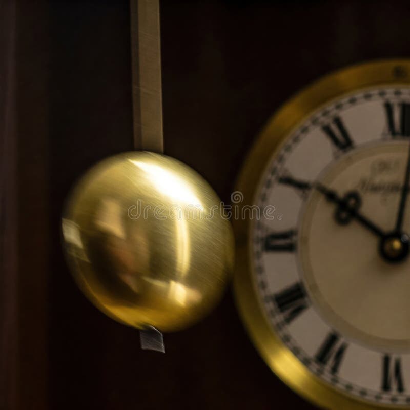 The Pendulum and Dial of an Antique Clock in Motion. Stock Image ...