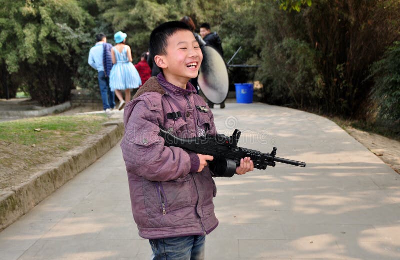 Pengzhou, China: Little Boy with Toy Gun Editorial Photography - Image ...
