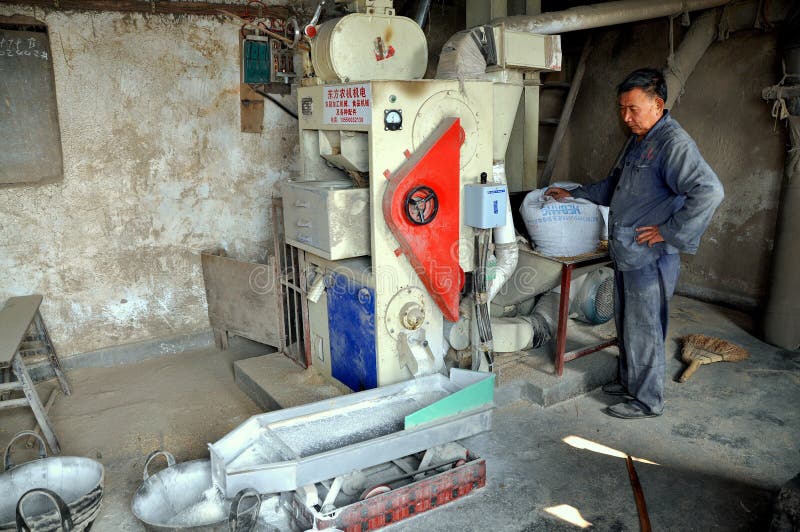 Pengzhou, China: Man Processing Rice Editorial Image - Image of machine ...