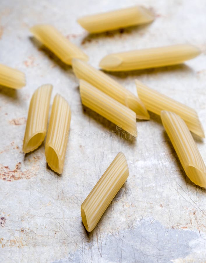 Dry penne on a plate stock photo. Image of dinner, tubes - 20120964