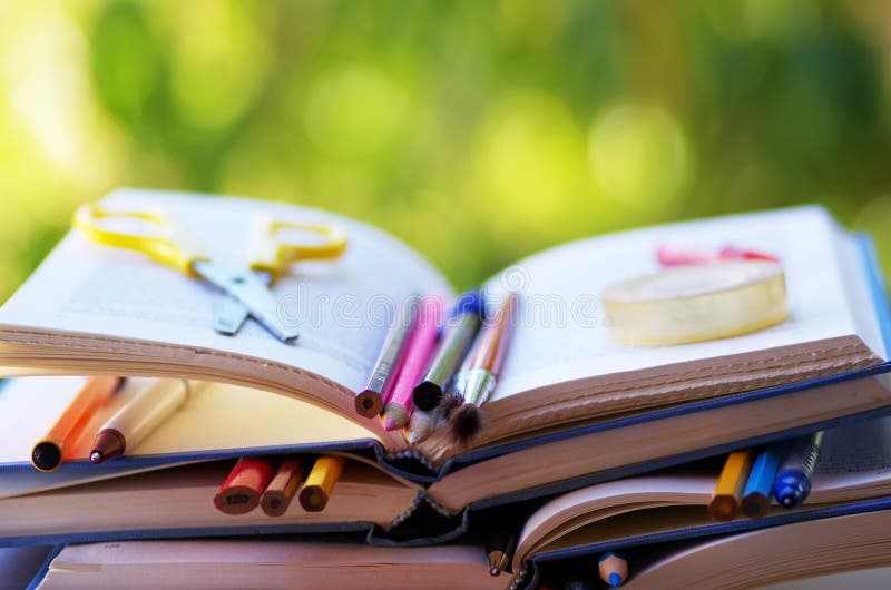 Pens and pencils in books stock image. Image of brush - 187770567