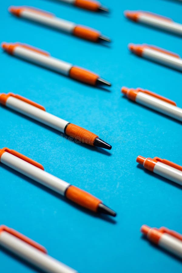 Pens Put Next To Each Other Over a Blue Surface Stock Image - Image of ...