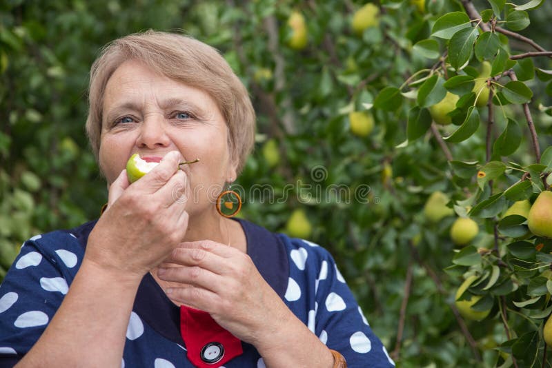 Pensioner Woman Eats Pear Under Pear Tree Stock Image - Image of lunch ...