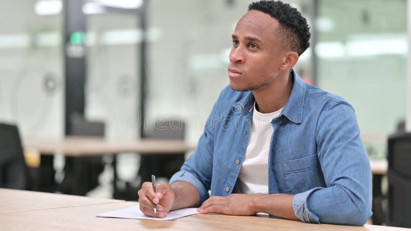 Pensive African Man Doing Paperwork, Writing Stock Photo - Image of ...
