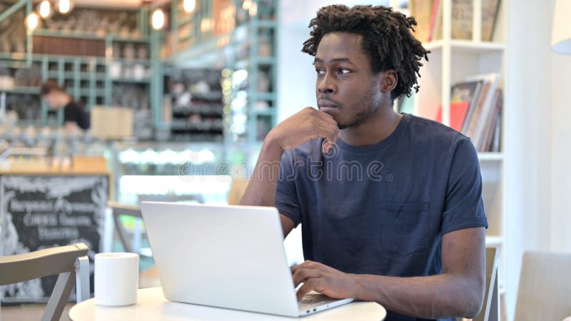 Pensive African Man Working on Laptop in Cafe Stock Image - Image of ...