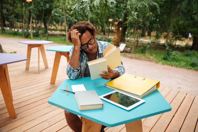 Pensive African Young Man Reading and Studying Stock Image - Image of ...