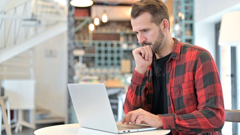 Pensive Beard Young Man Reading on Laptop in Cafe Stock Image - Image ...
