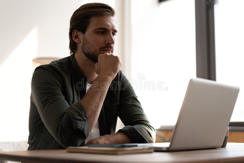 Pensive Bearded Man Sitting at Table Work at Laptop Thinking of Problem ...