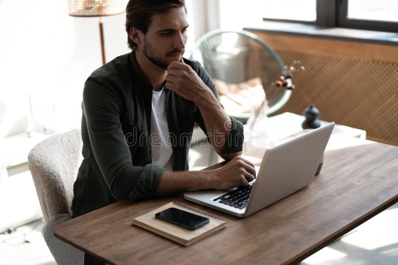 Pensive Bearded Man Sitting at Table Work at Laptop Thinking of Problem ...