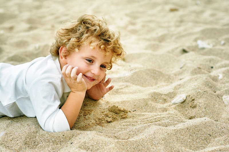 Pensive Boy Lying on the Sand , Closeup Portrait . Stock Photo - Image ...