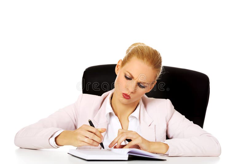 Pensive Business Woman Taking Notes Behind the Desk Stock Image - Image ...